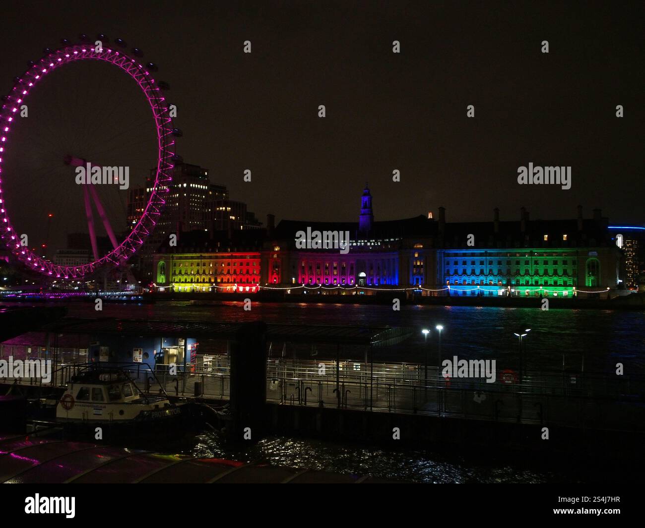 The House of Parliament and London Eye lit up at night in rainbow ...
