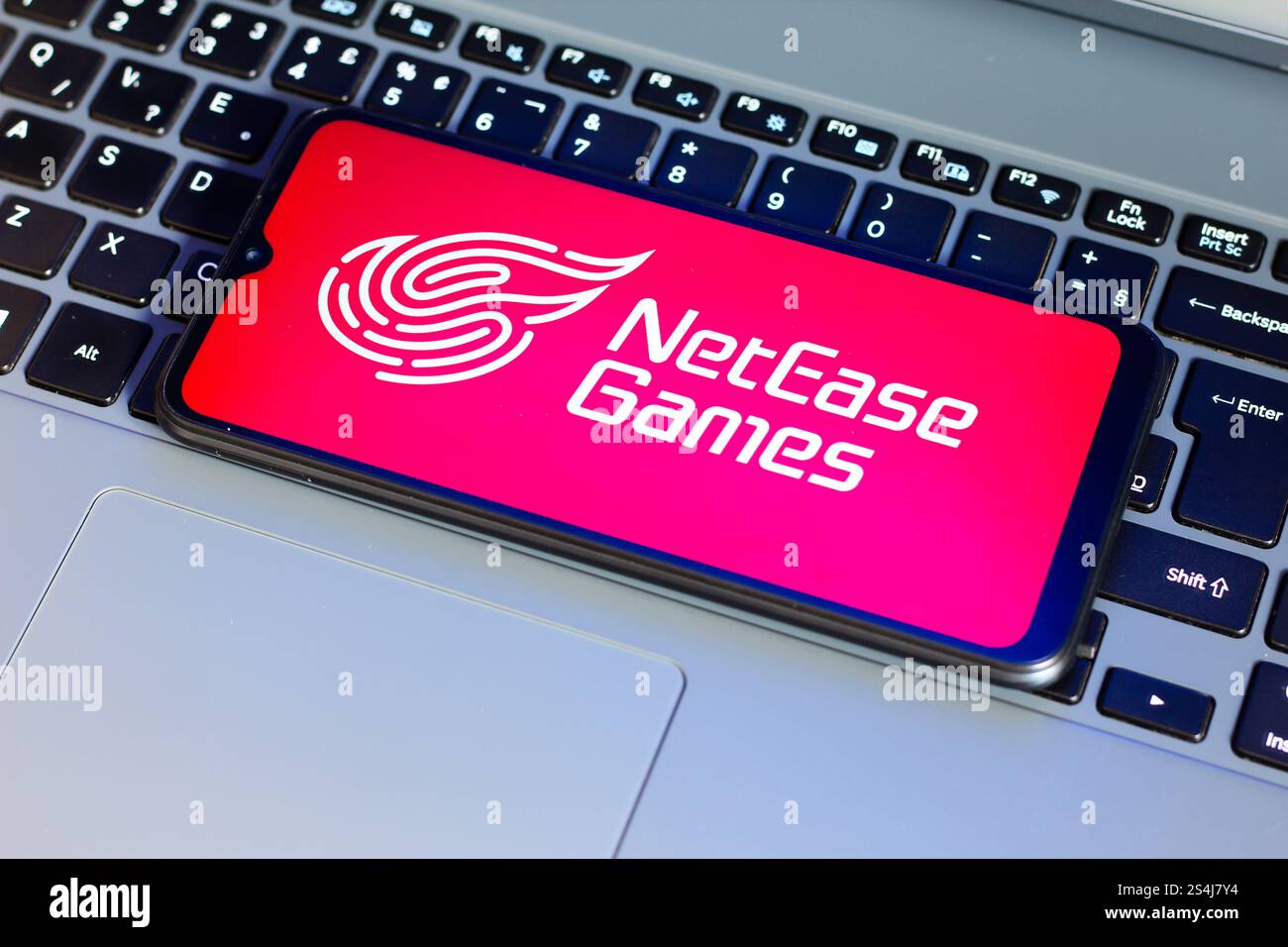 In this photo illustration, the NetEase Games logo is seen displayed on a smartphone screen next ...