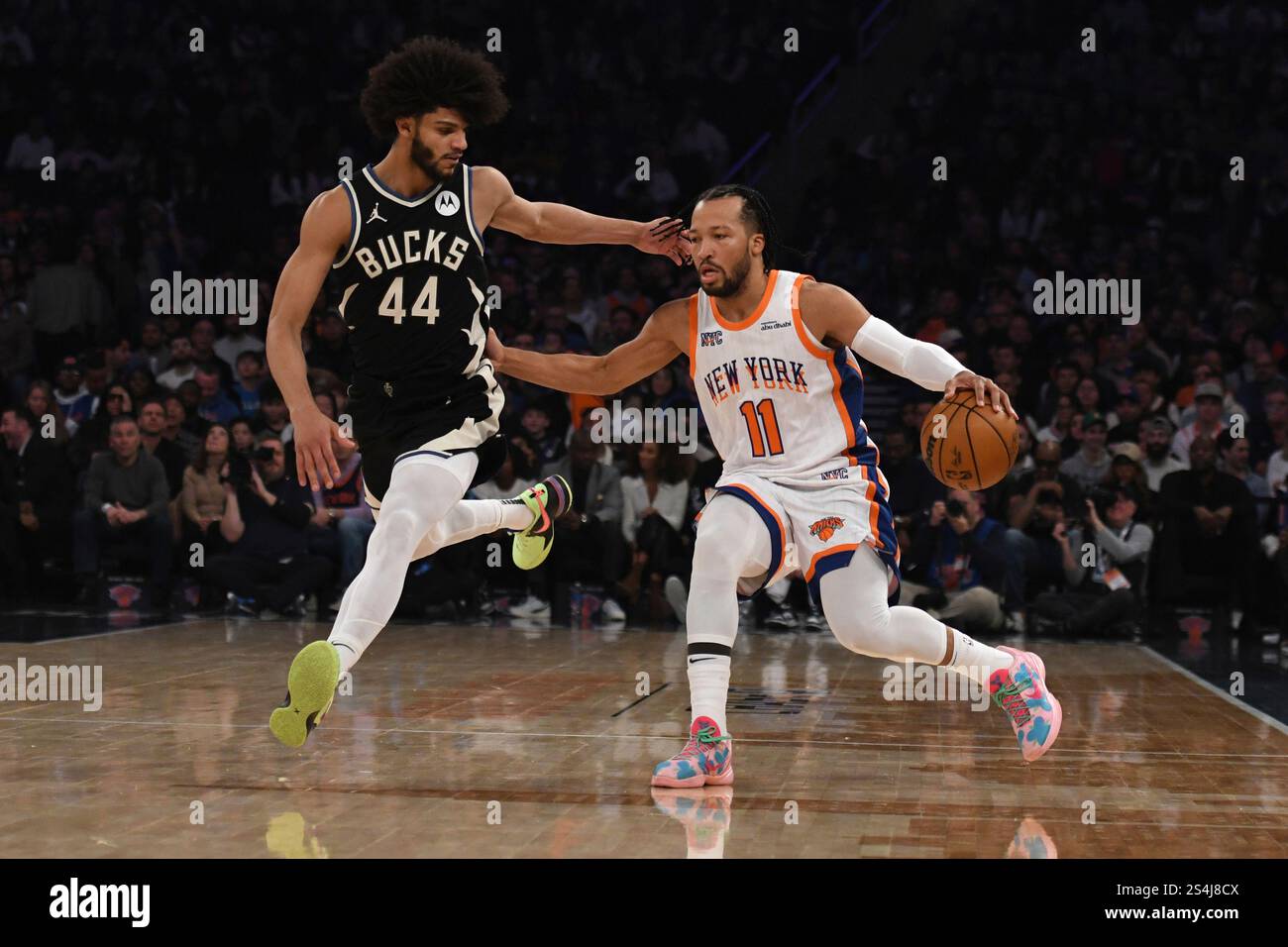 New York Knicks' Jalen Brunson, right, dribbles past Milwaukee Bucks ...