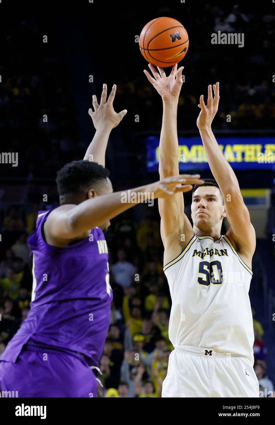 Michigan center Vladislav Goldin (50) shoots against Washington center ...