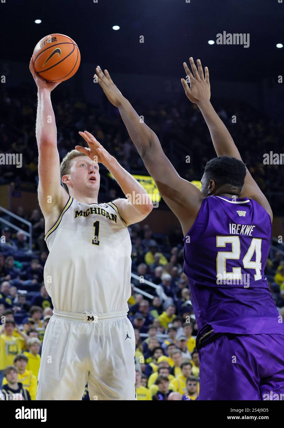 Michigan center Danny Wolf (1) takes a shot against Washington center ...