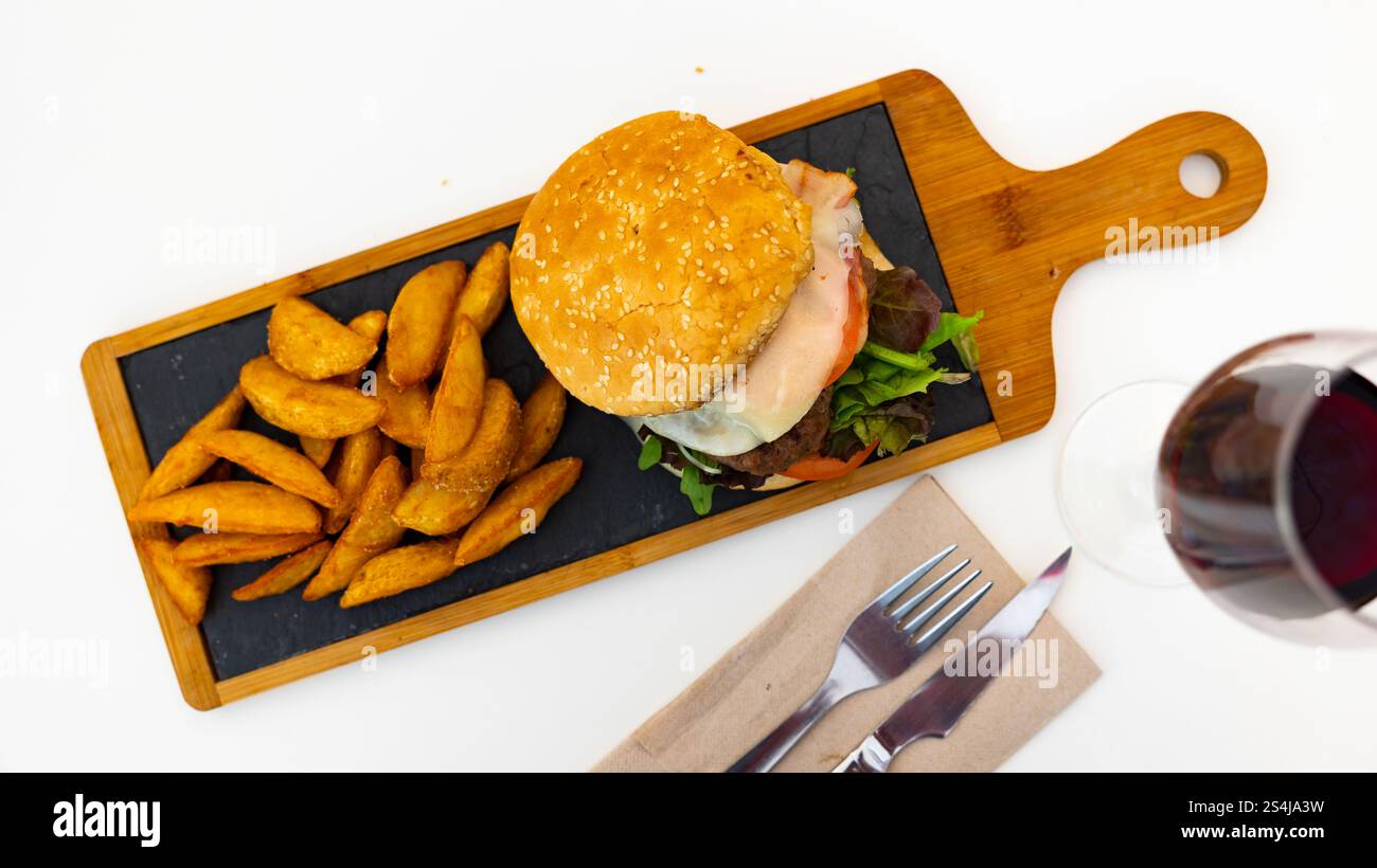 Delicious cheeseburger with beef patty and cheese on plate, with french ...