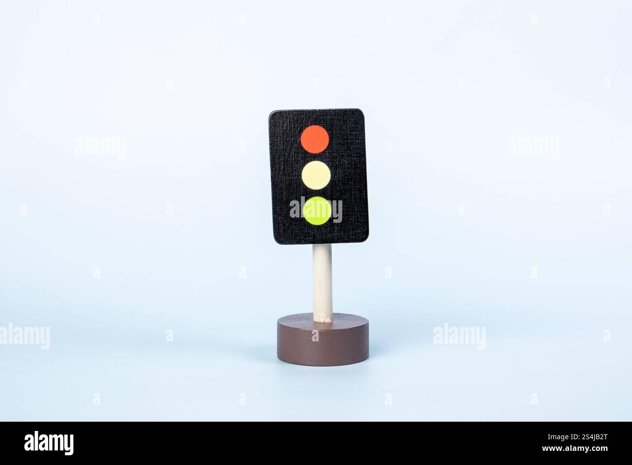 Miniature traffic light on a light background Stock Photo - Alamy
