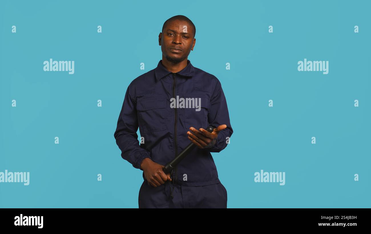 Security guard smacking hand with baton, intimidating suspects ...