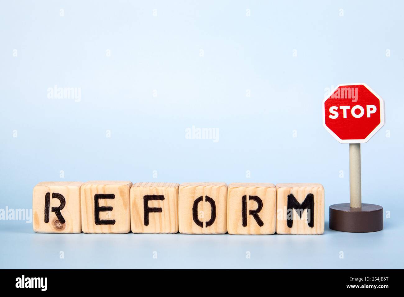 Stop Reform. Word from wooden alphabet blocks on a light background ...
