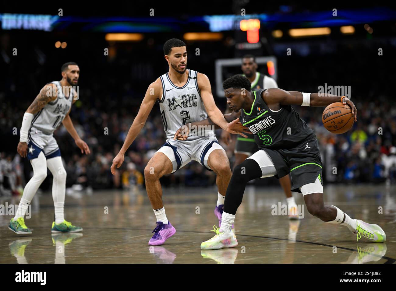 Minnesota Timberwolves guard Anthony Edwards (5) is defended by Orlando ...