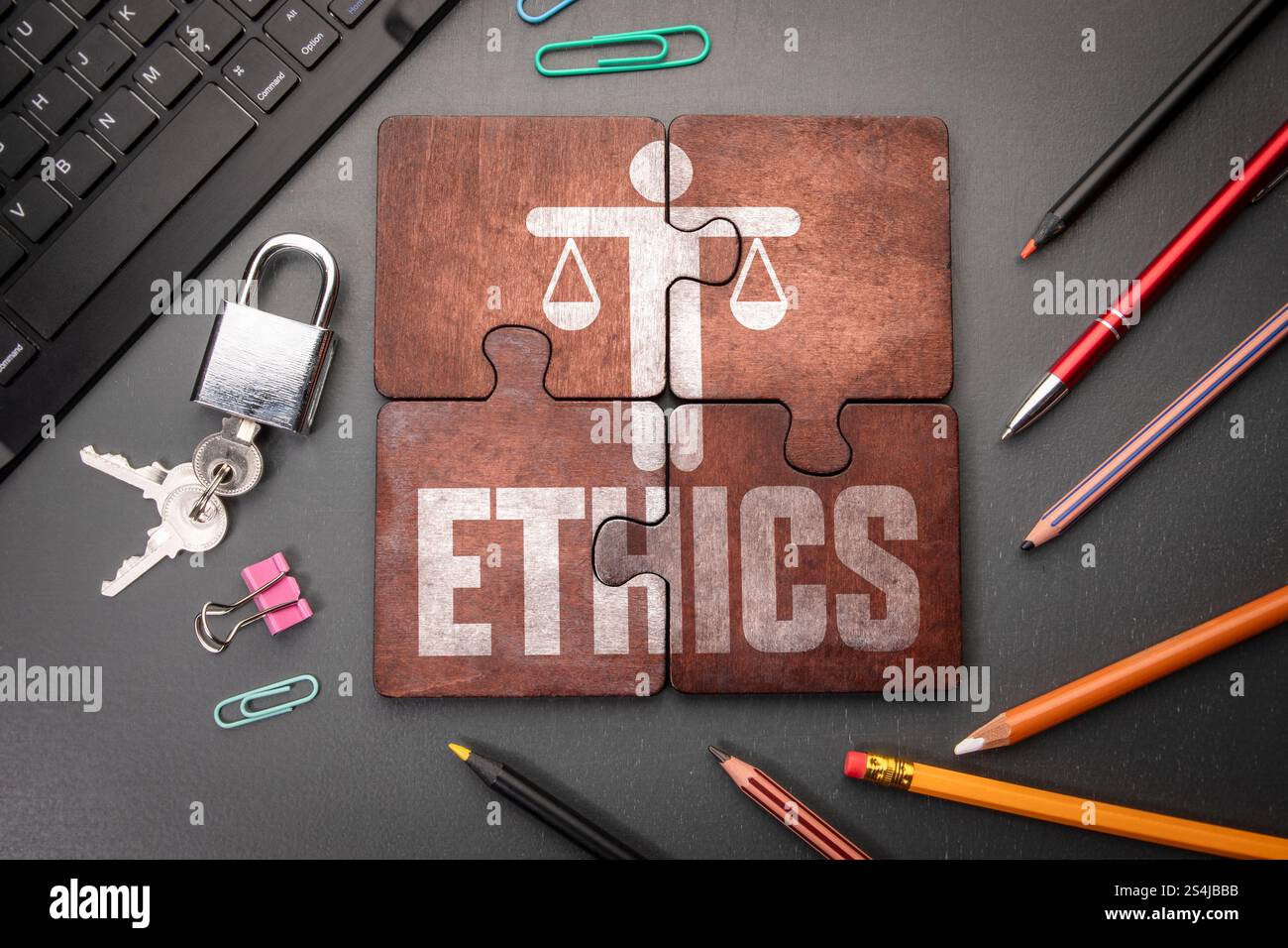ETHICS Concept. Wooden puzzle pieces with text on a dark office table ...