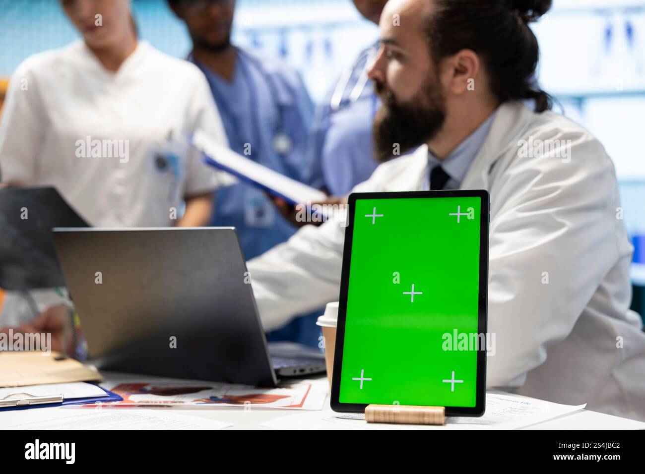 Diverse group of specialists work next to chroma key isolated display ...