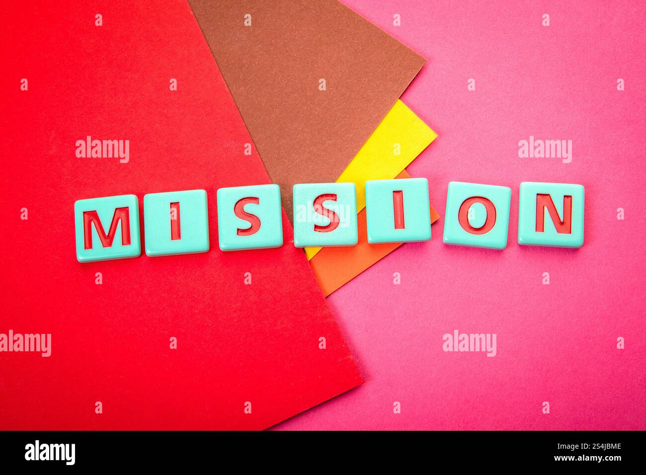 MISSION. Alphabet letter tiles on a red textured background Stock Photo ...