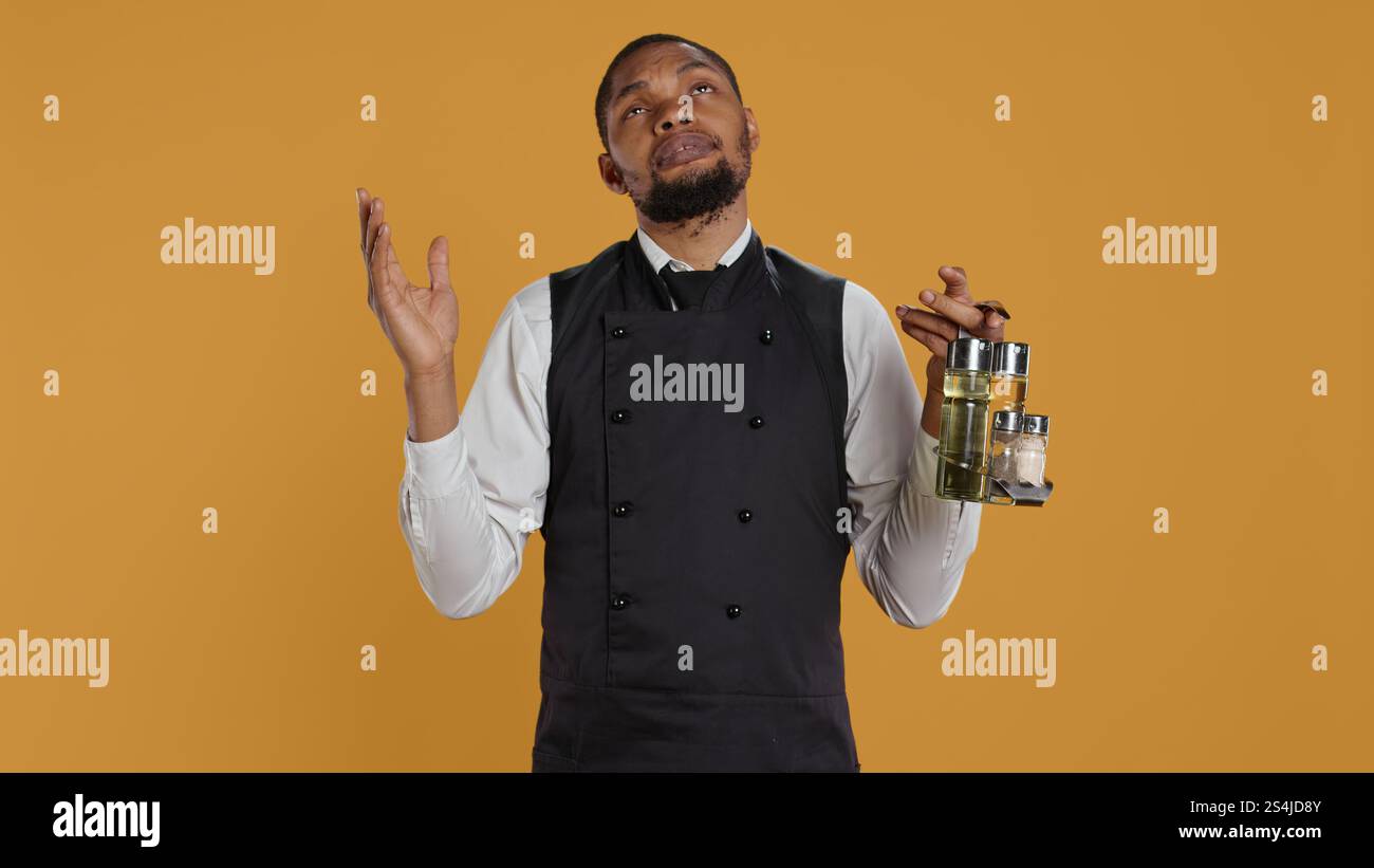 Spiritual waiter in apron praying to Jesus Christ with belief, being ...