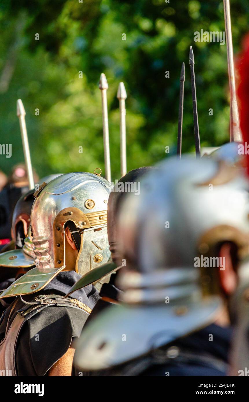 detail of the helmets of Roman legionary soldiers in formation at a historical reenactment party ...