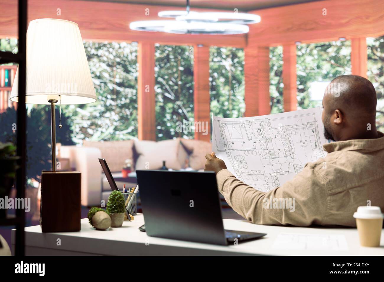 Businessman evaluating architectural sketches and planning an office renovation, focusing on ...