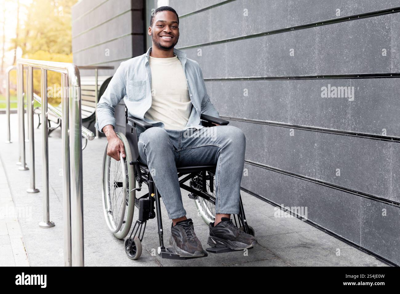 Handicapped accessible city. Positive impaired Afro man in wheelchair ...
