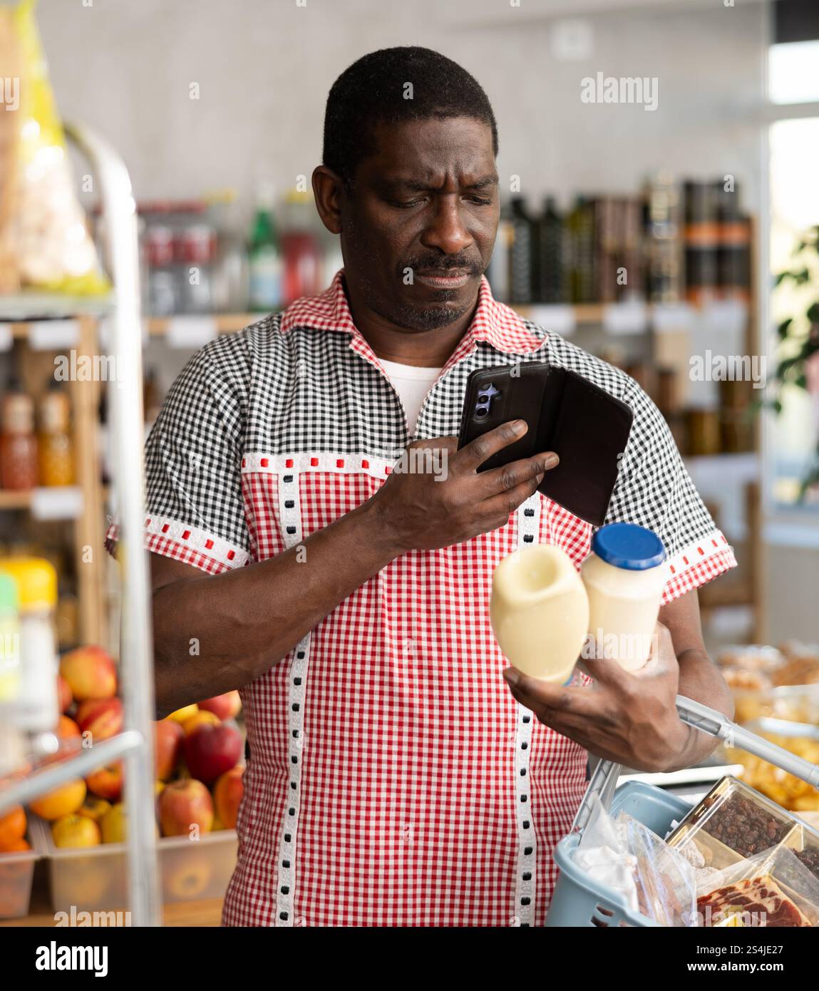 Adult man scanning qr code for mayonnaise Stock Photo - Alamy