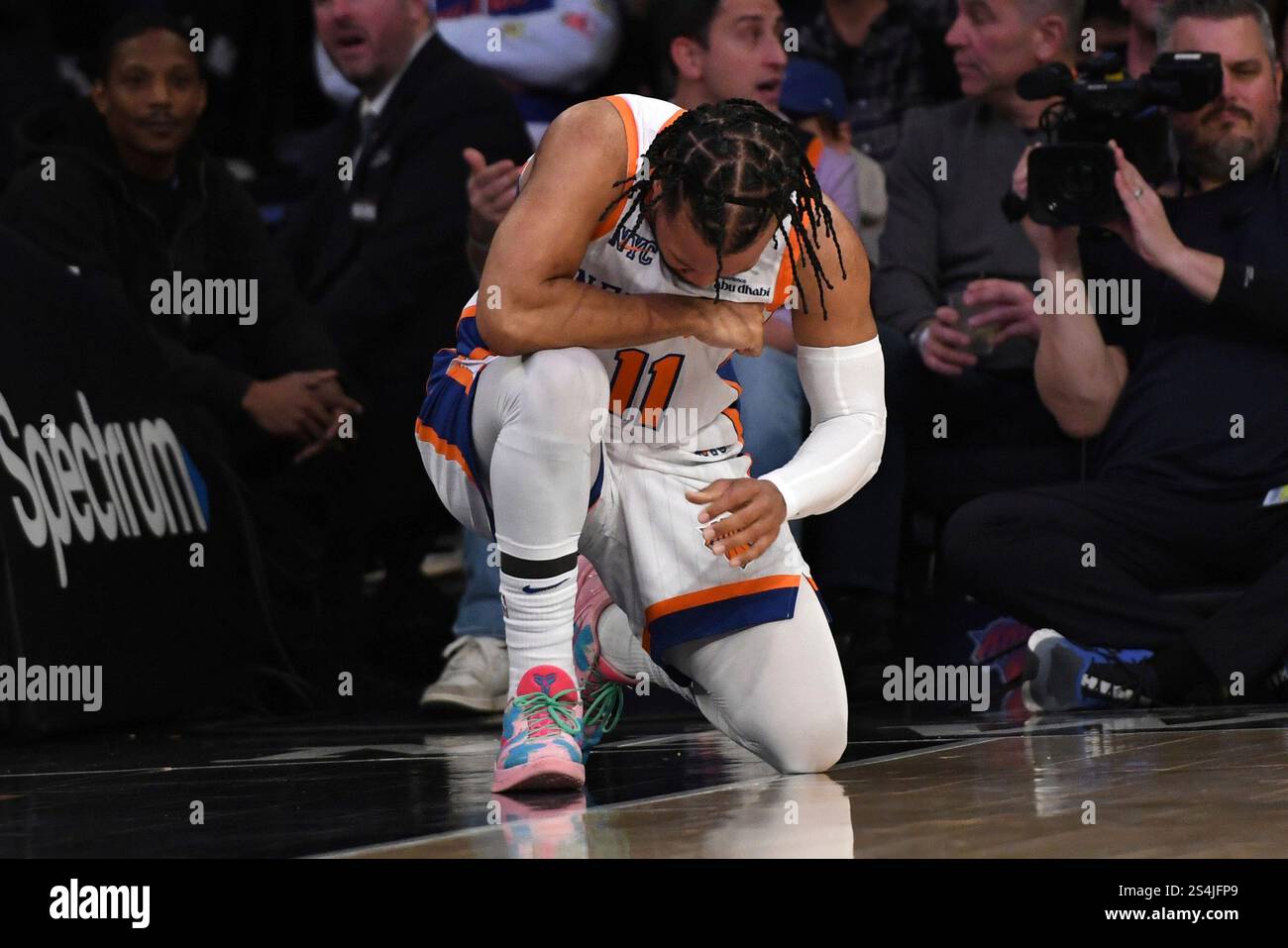 New York Knicks' Jalen Brunson reacts after getting knocked over during ...