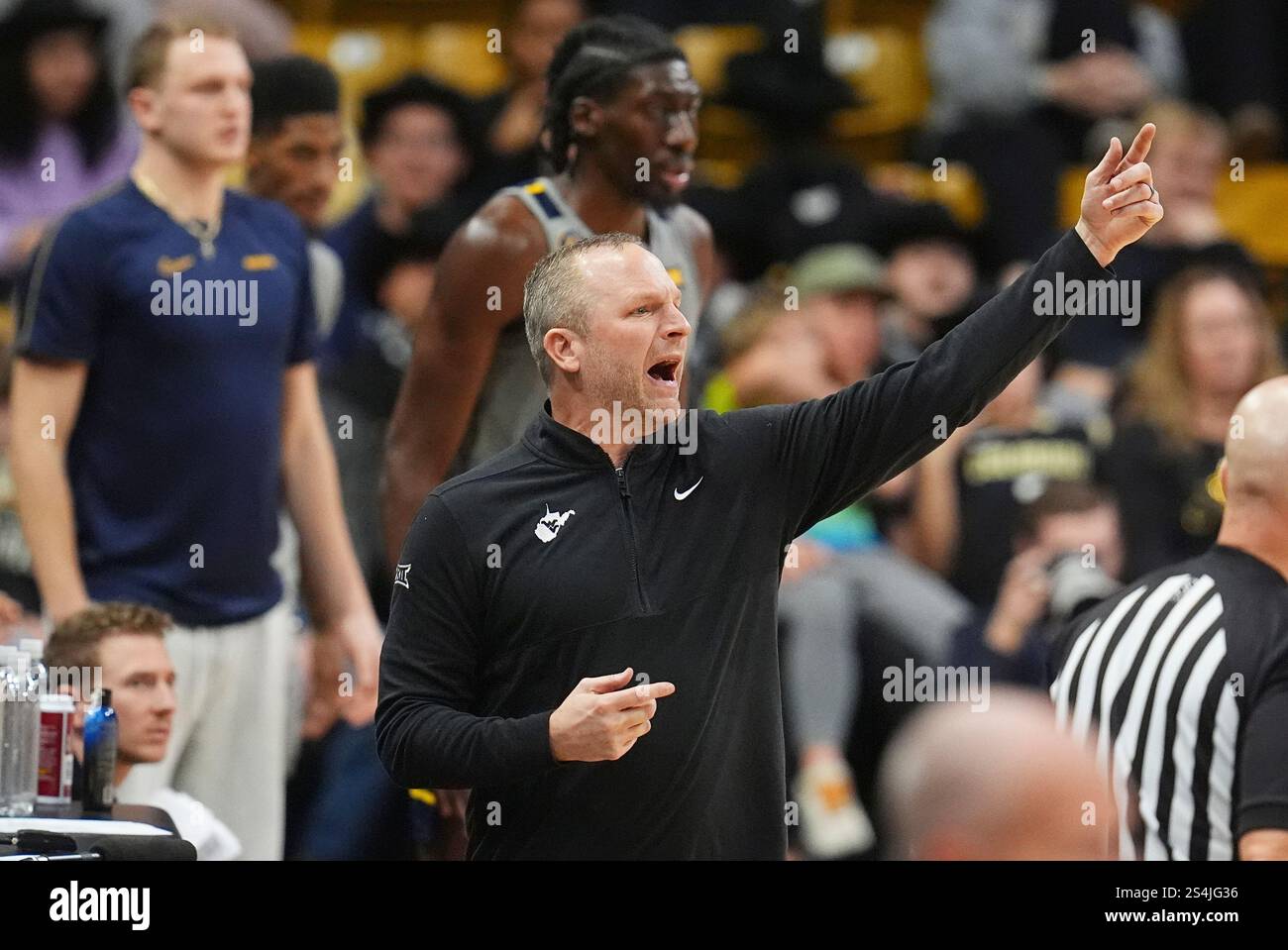 West Virginia head coach Darian DeVries directs his team against ...