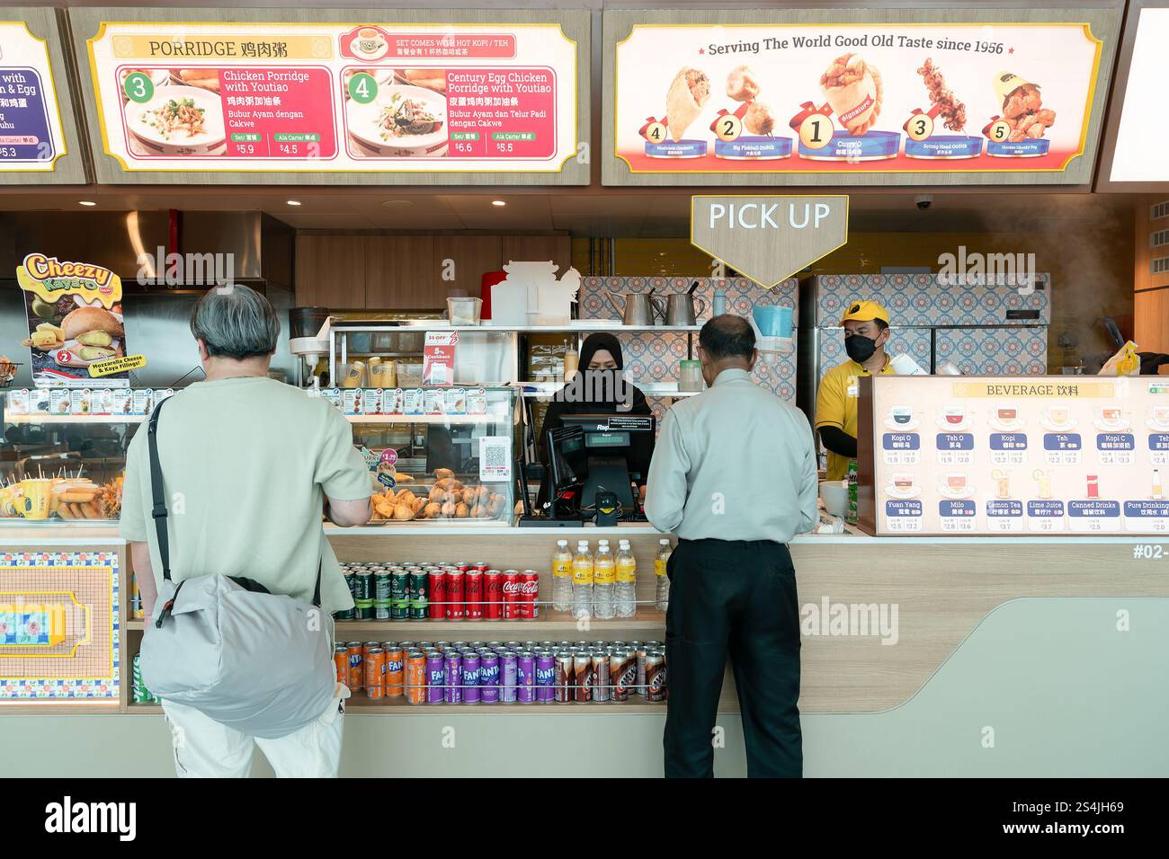 SINGAPORE - AUGUST 25, 2024: a man interacts with the staff at the Old ...