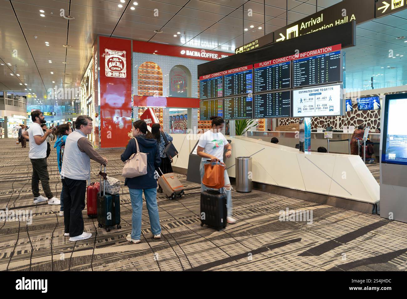 SINGAPORE - AUGUST 25, 2024: passengers at Changi Airport stand near ...