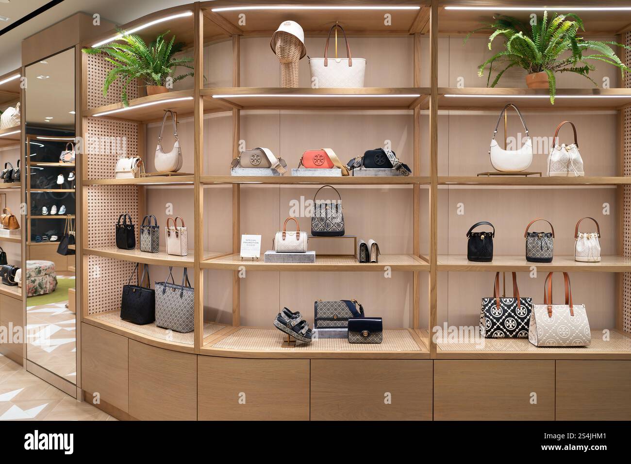 SINGAPORE - AUGUST 25, 2024: various handbags on display at Tory Burch ...