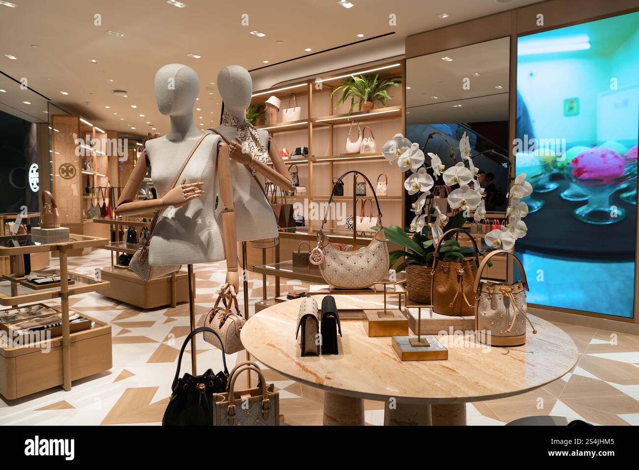 SINGAPORE - AUGUST 25, 2024: various handbags on display at Tory Burch ...