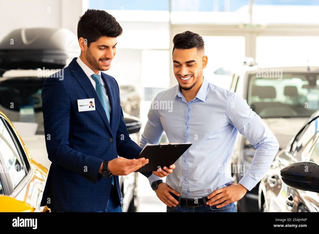 Attractive showroom manager showing customer car specifications Stock ...