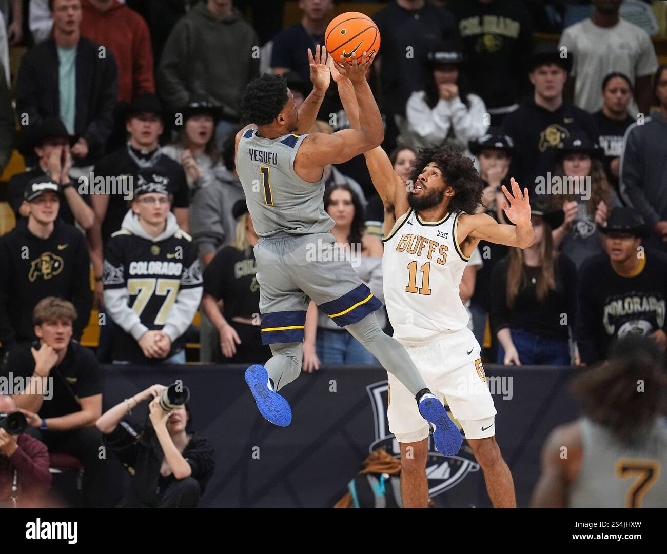 West Virginia guard Joseph Yesufu (1) goes up for a basket as Colorado ...