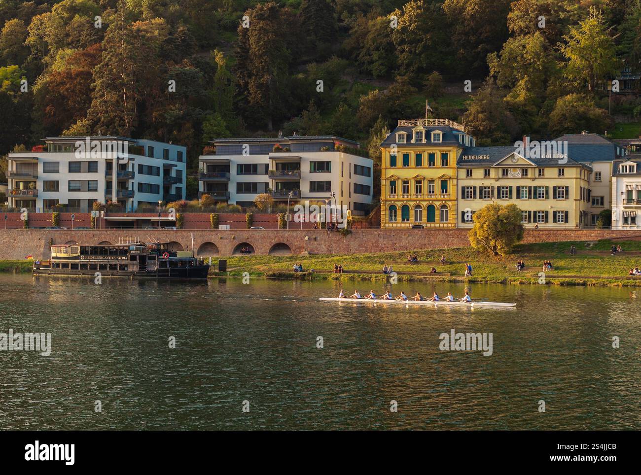 A picturesque riverside in Heidelberg, Germany, with vibrant ...