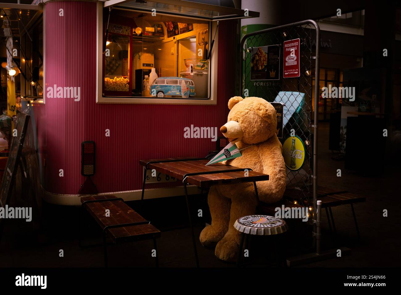 popcorn stall with table outside and big teddy bear Stock Photo - Alamy