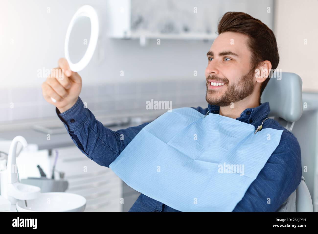 Male patient looking at his beautiful healthy white smile Stock Photo ...