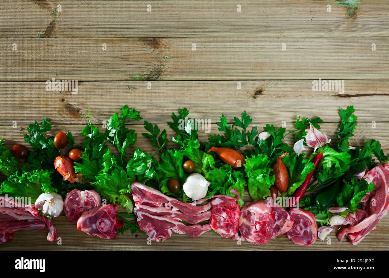 Natural border with lamb and greens Stock Photo - Alamy
