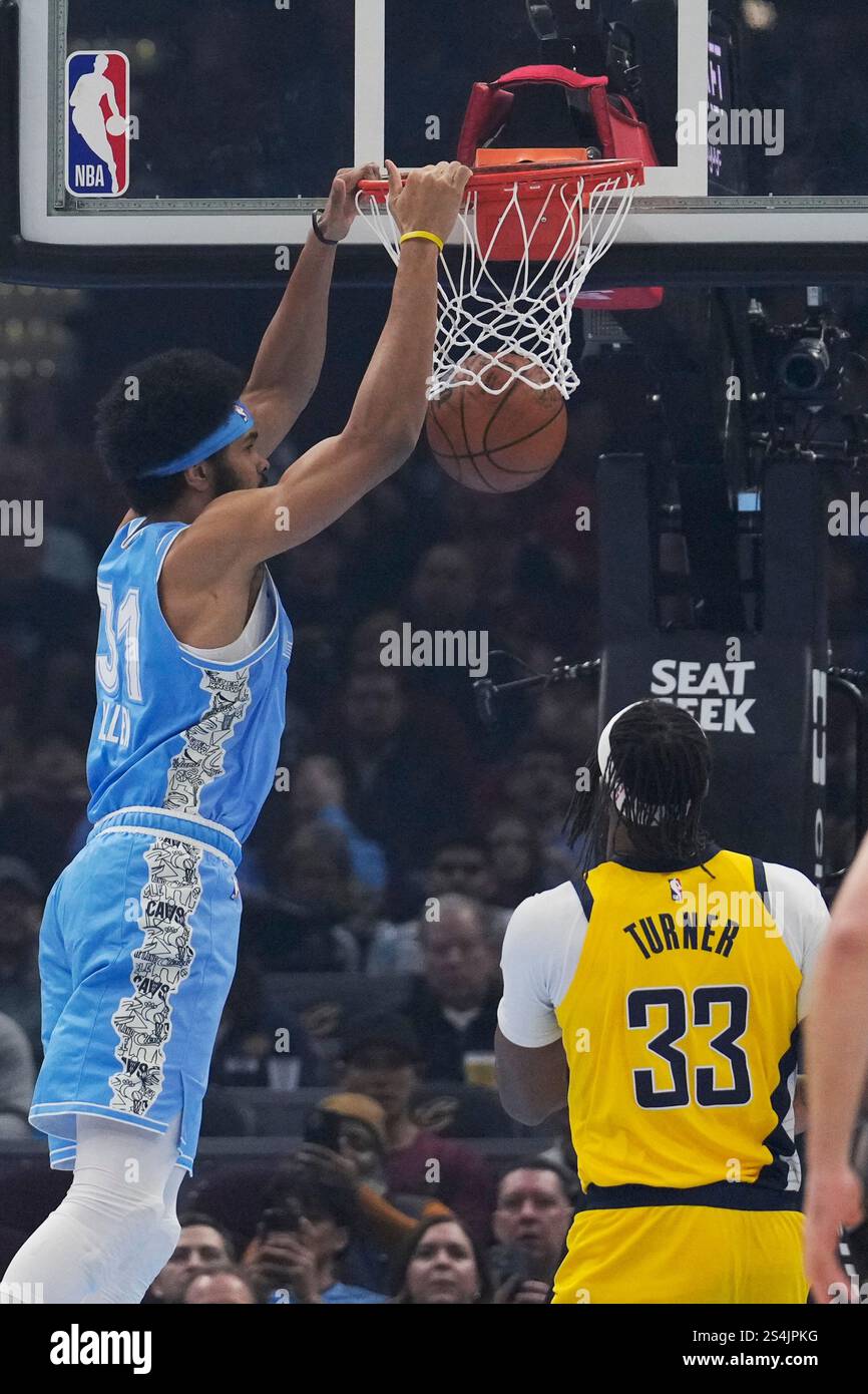 Cleveland Cavaliers center Jarrett Allen, left, dunks on front of ...