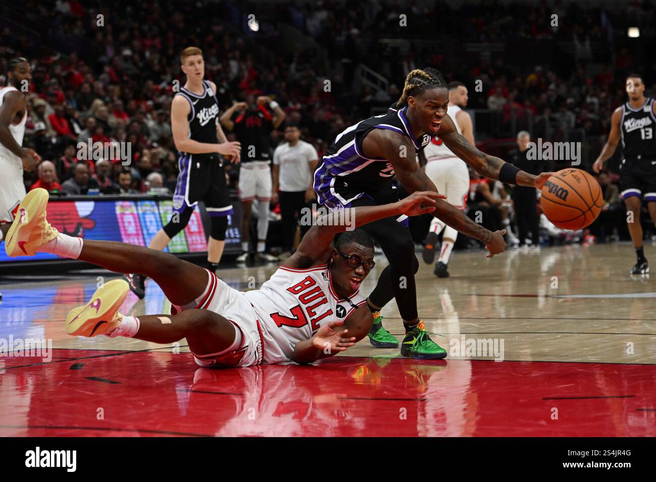 Sacramento Kings' Keon Ellis, top, battles Chicago Bulls' Jalen Smith ...