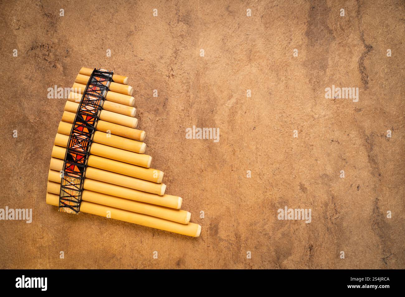 bamboo pan flute instrument from Peru against textured art paper with a ...