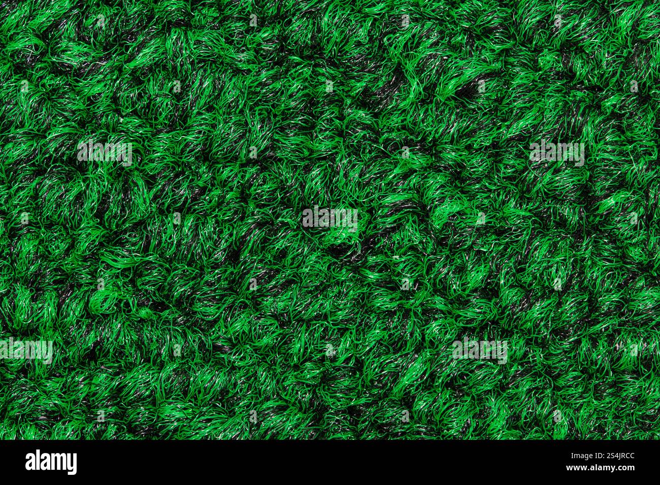 Green nylon yarn woven mat background textured carpet sample closeup ...