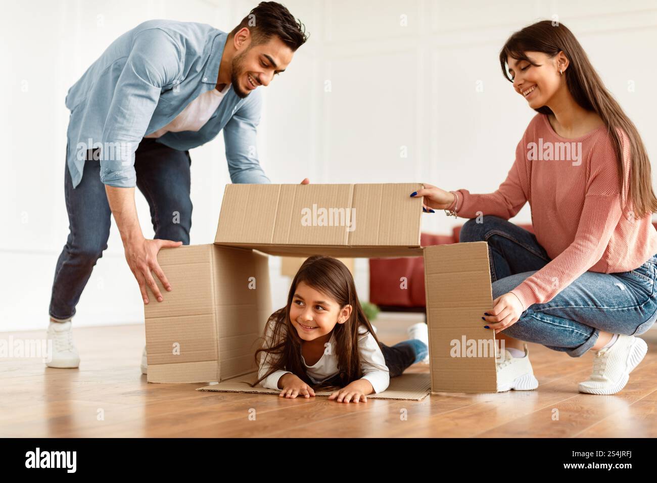 Happy loving young family celebrating moving day together Stock Photo ...