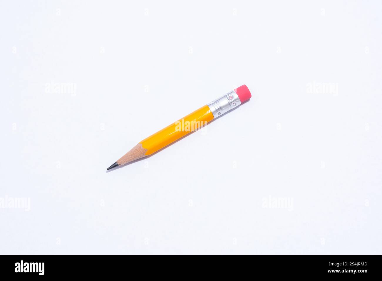 A short yellow pencil isolated on a white background. The pencil has an ...