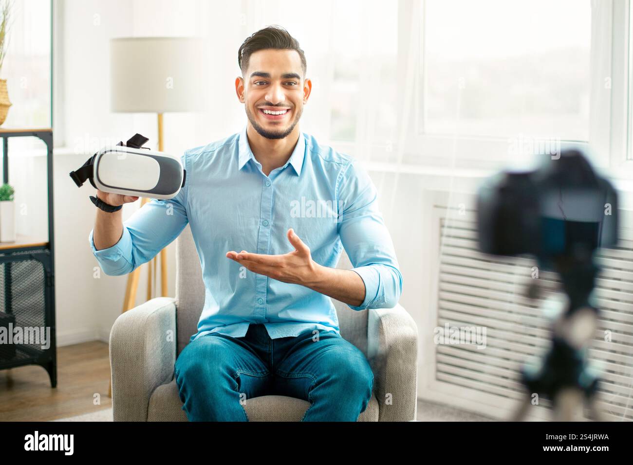 Arab guy vlogger making tech product review, presenting VR headset ...