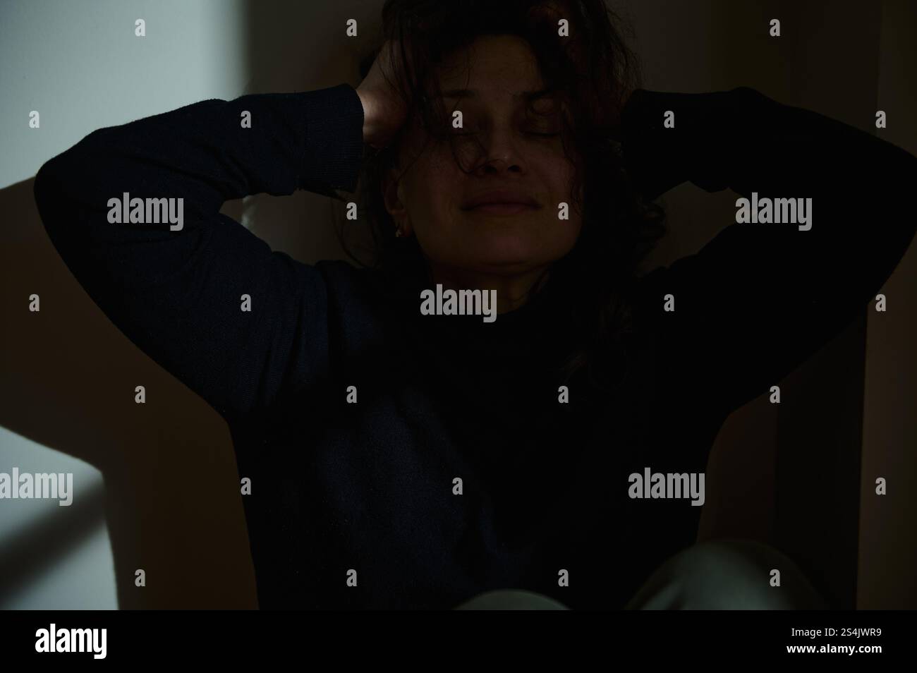 A dramatic depiction of an emotional moment, highlighting shadows, a ...