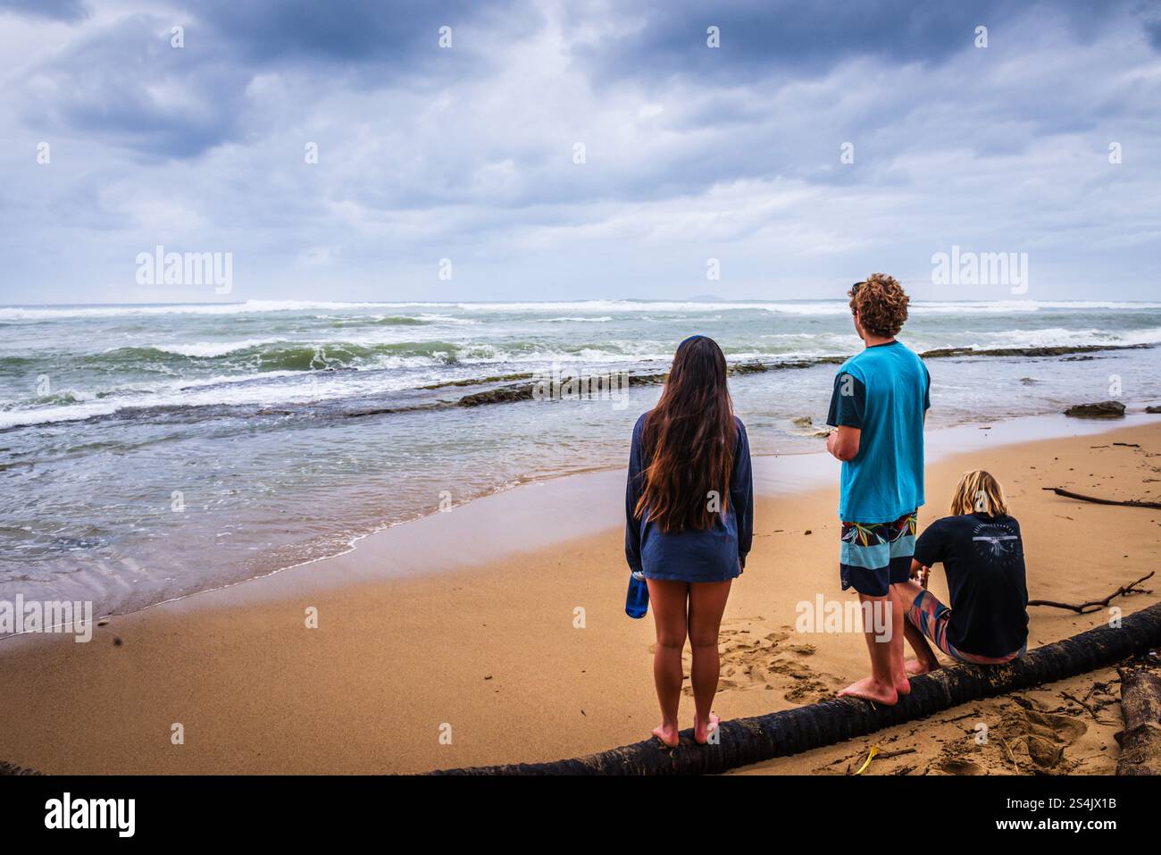 Rincon, Puerto Rico - March 4, 2018: Three young people observe the ...