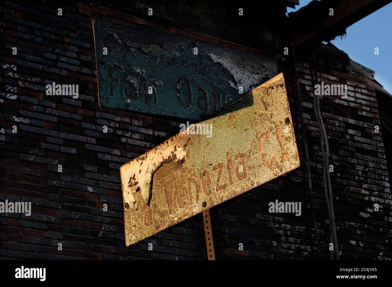 Charred street signs are pictured at the intersection of Fair Oaks ...