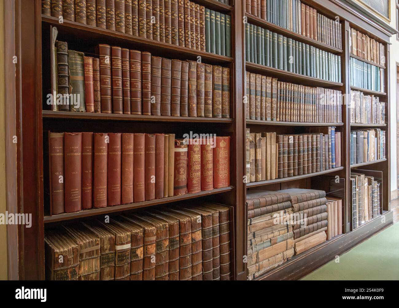 Lacock United Kingdom - August 9 2024; Bookcase loaded with ancient ...