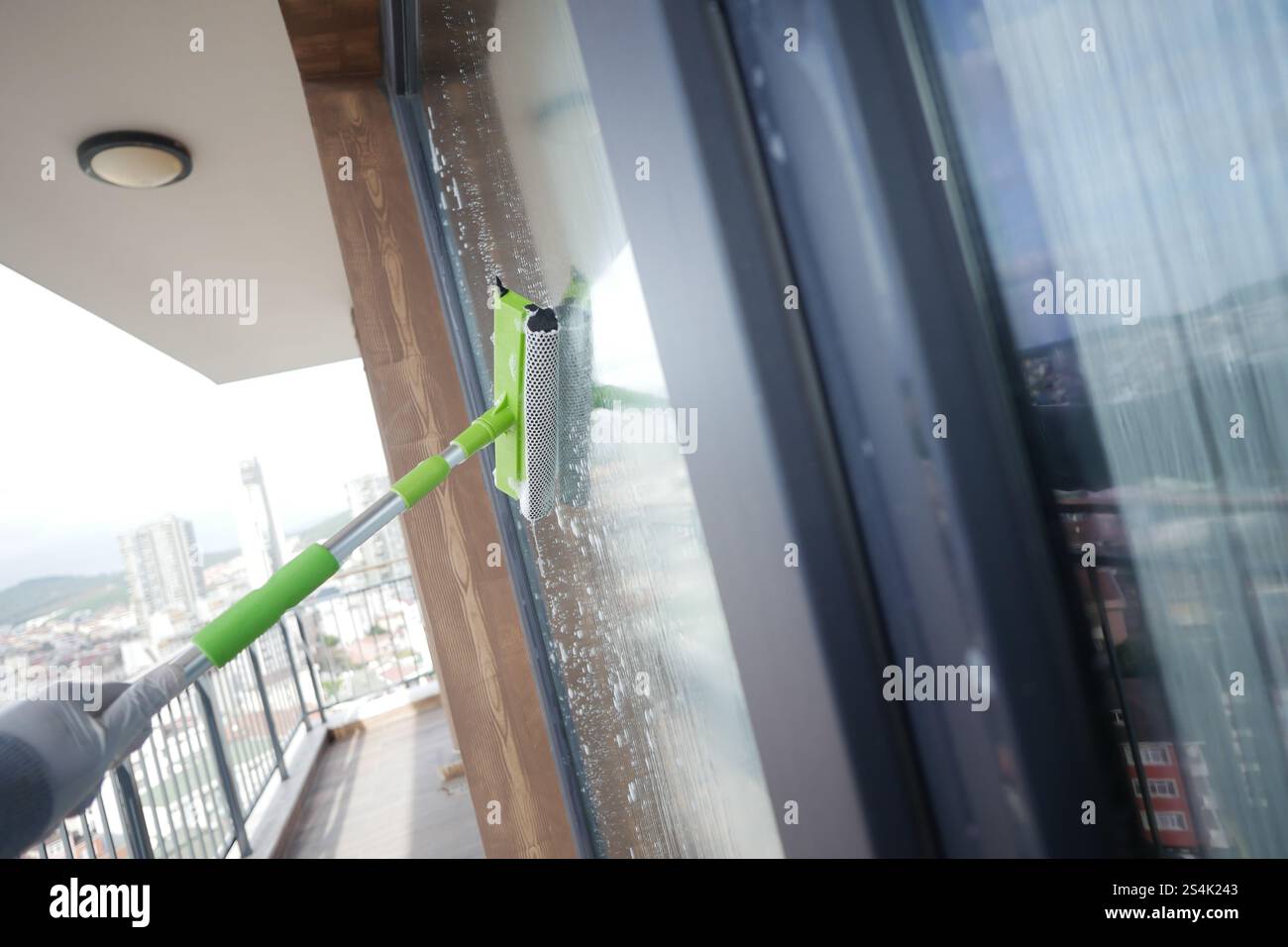 Rubber squeegee cleans a soaped window Stock Photo - Alamy