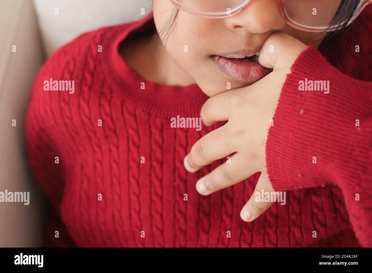 child girl biting her nails at home Stock Photo - Alamy