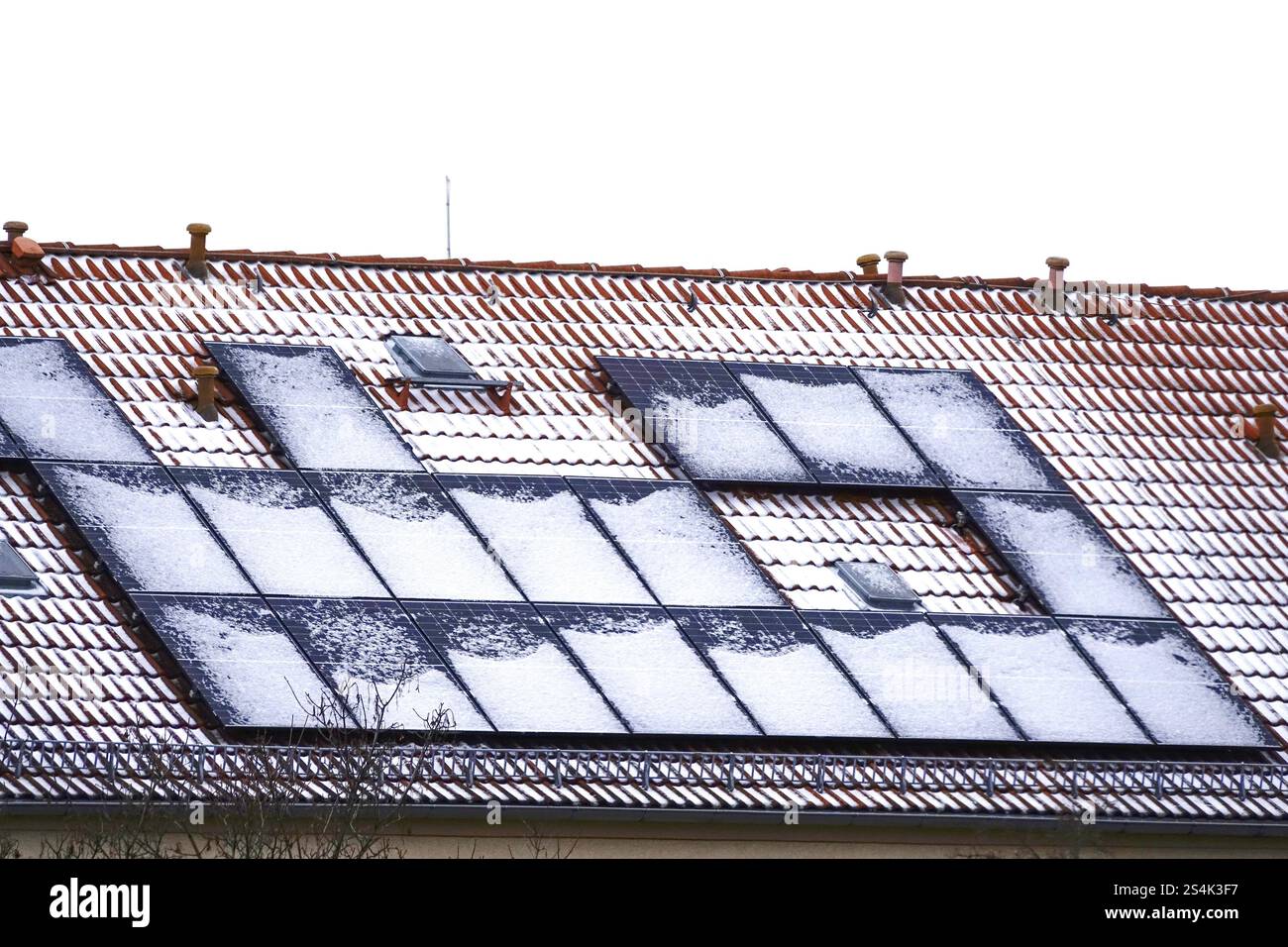 Snow-covered solar modules on a residential building, winter, Germany ...