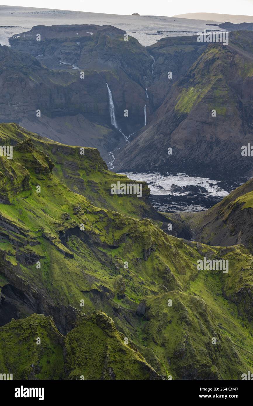 Moss-covered mountains at sunset, waterfalls on a cliff at ...