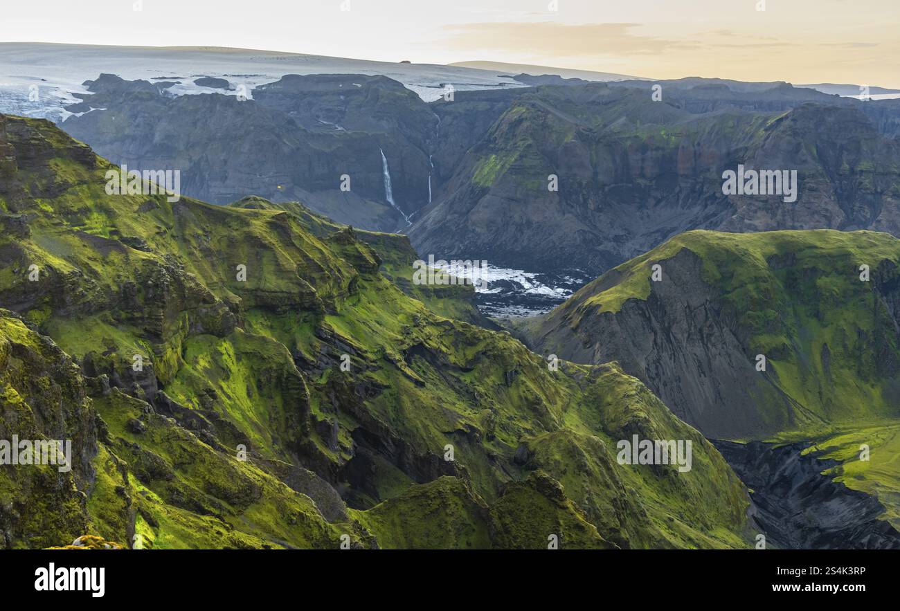 Moss-covered mountains at sunset, waterfalls on a cliff at ...