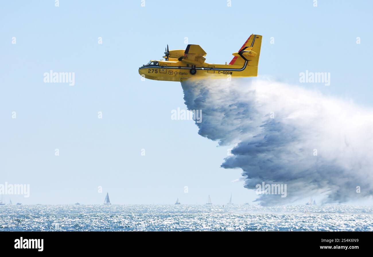 Water Bomber CL-415 firefighting amphibious aircraft releasing water at ...
