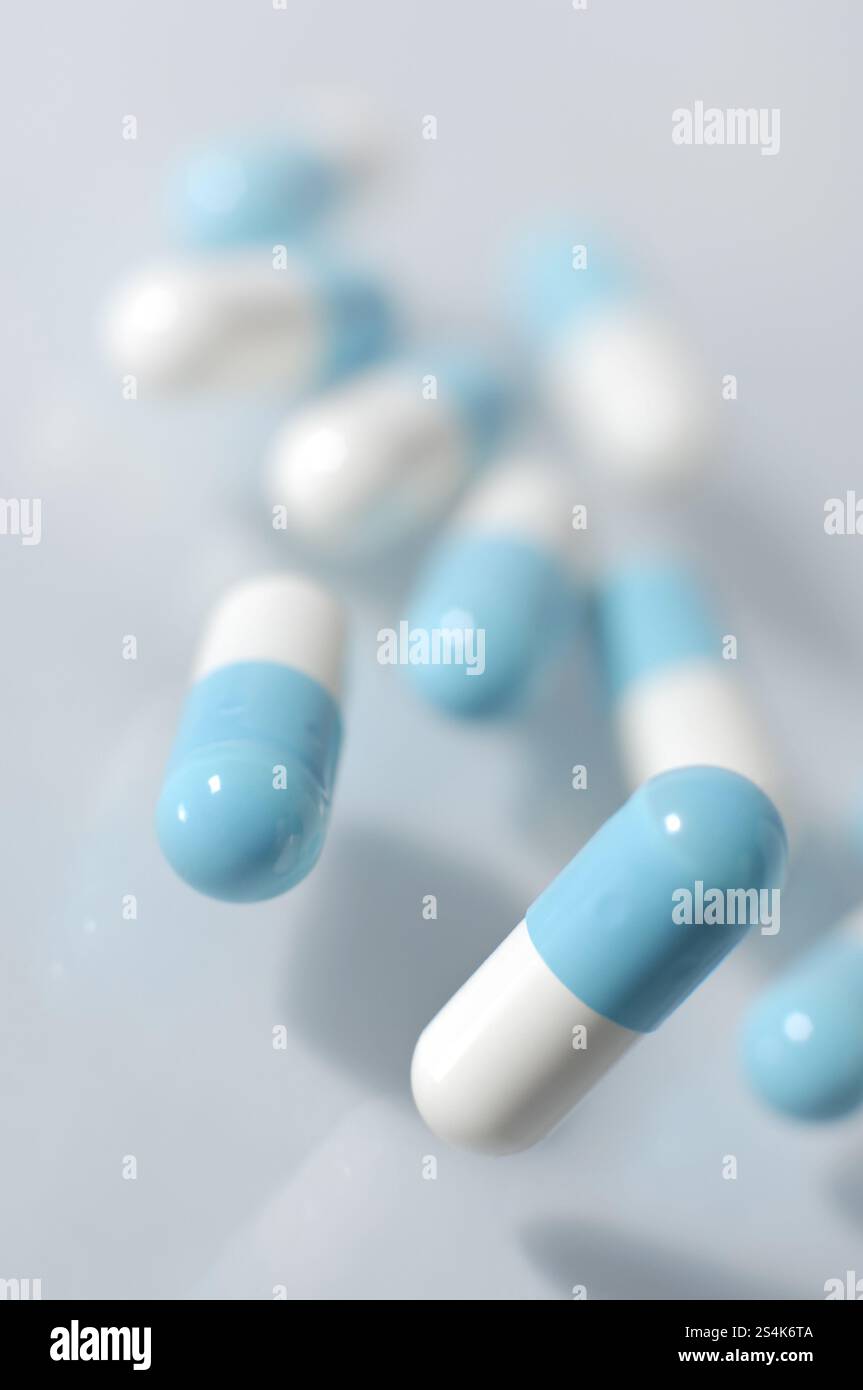 Stock photo of White-blue capsules Medication pills isolated on white ...