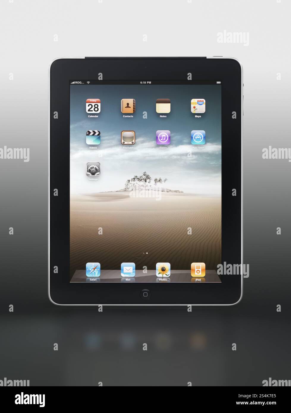 Apple iPad 3G tablet with desktop icons on its display isolated on gray ...
