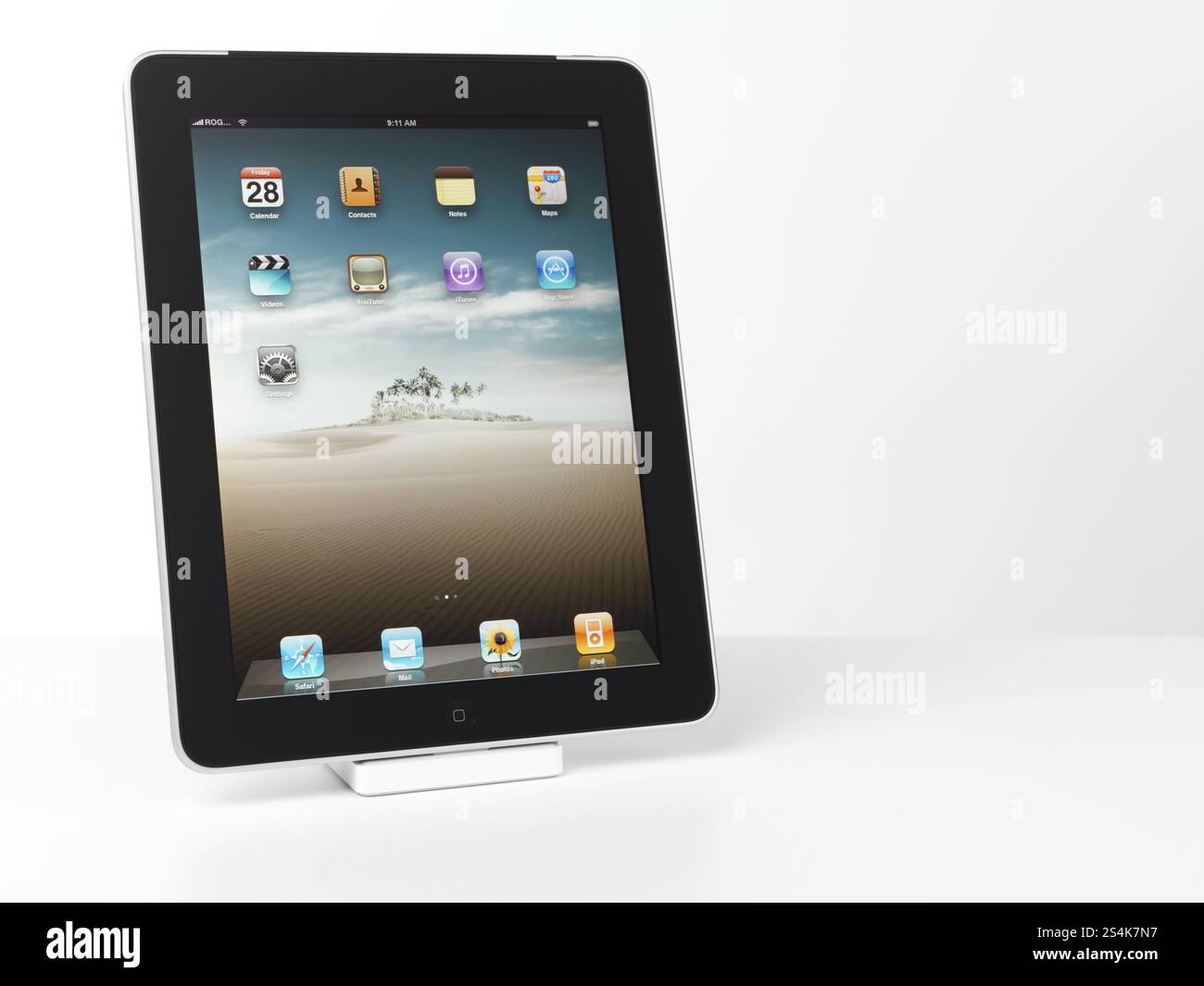 Apple iPad 3G tablet computer standing in its dock isolated on white ...